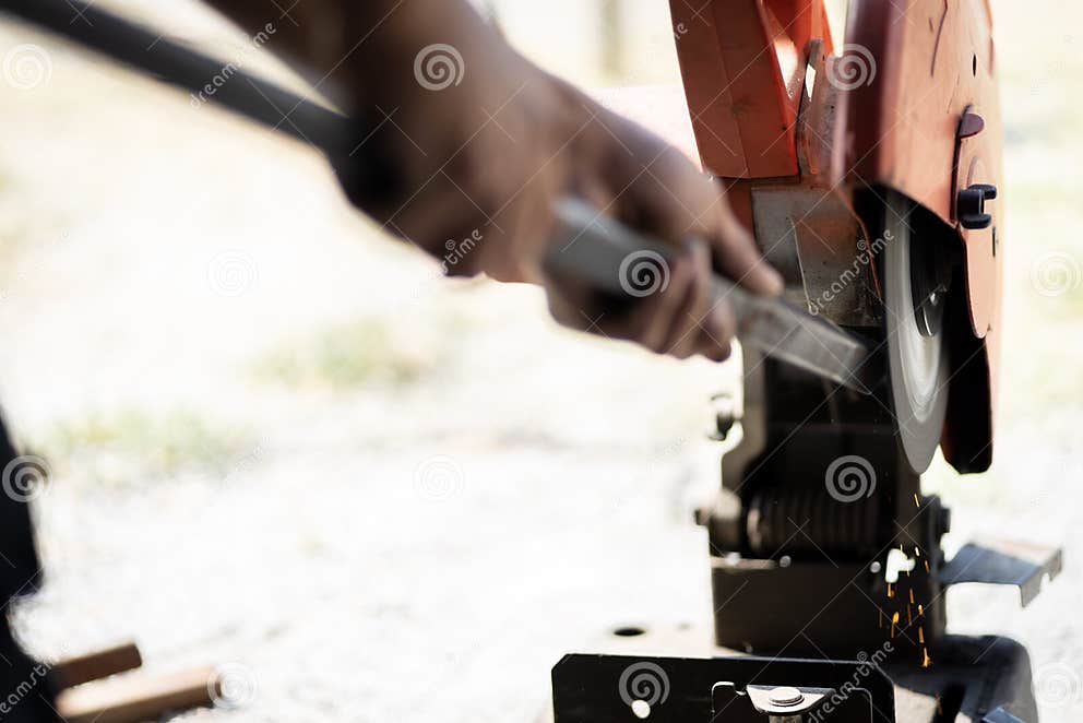 A Blacksmith is Using a Sharpener, Sparks Come Out while Cutting Stock ...