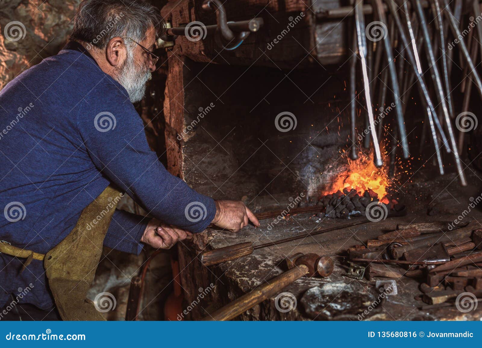 Blacksmith at Work with Glowing Irons. Stock Photo - Image of orange ...
