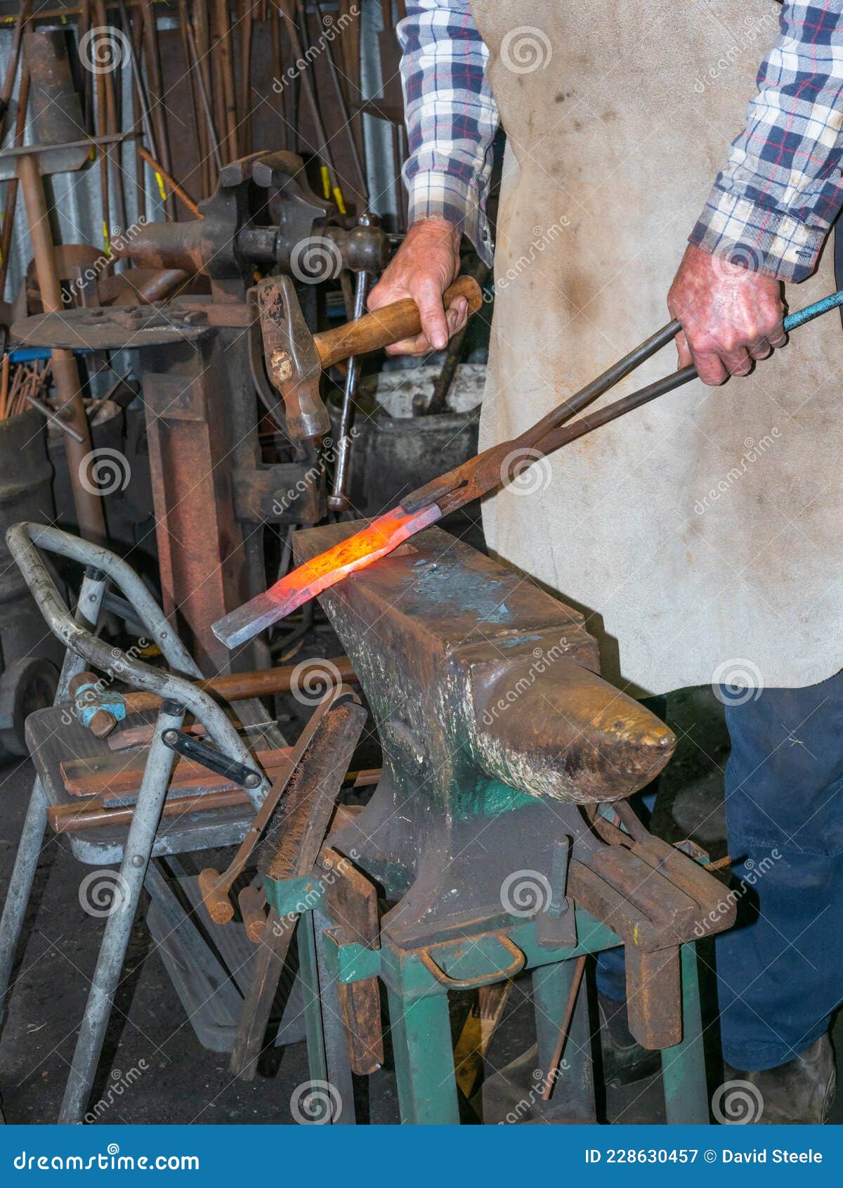 A Blacksmith at his Anvil stock image. Image of craftsman - 228630457