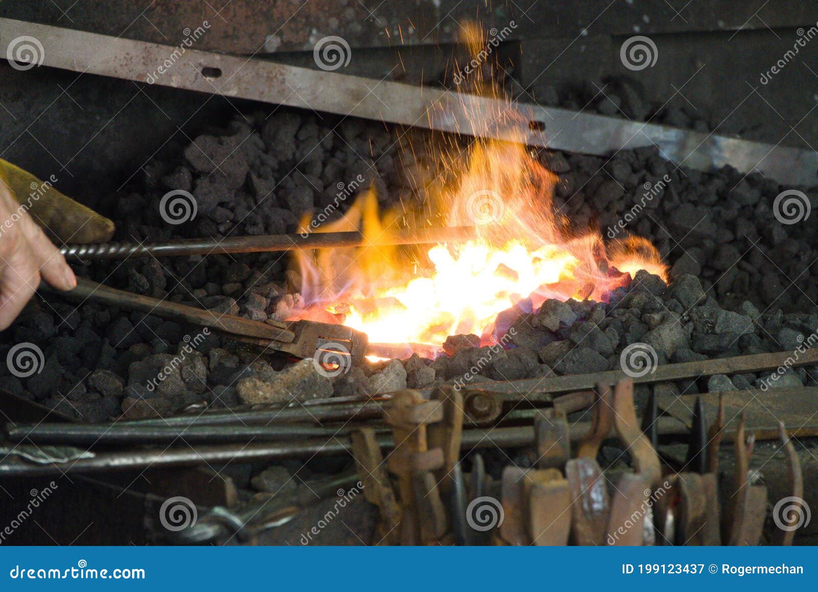 Blacksmith Working at His Forge with Metal in White Flame Editorial ...
