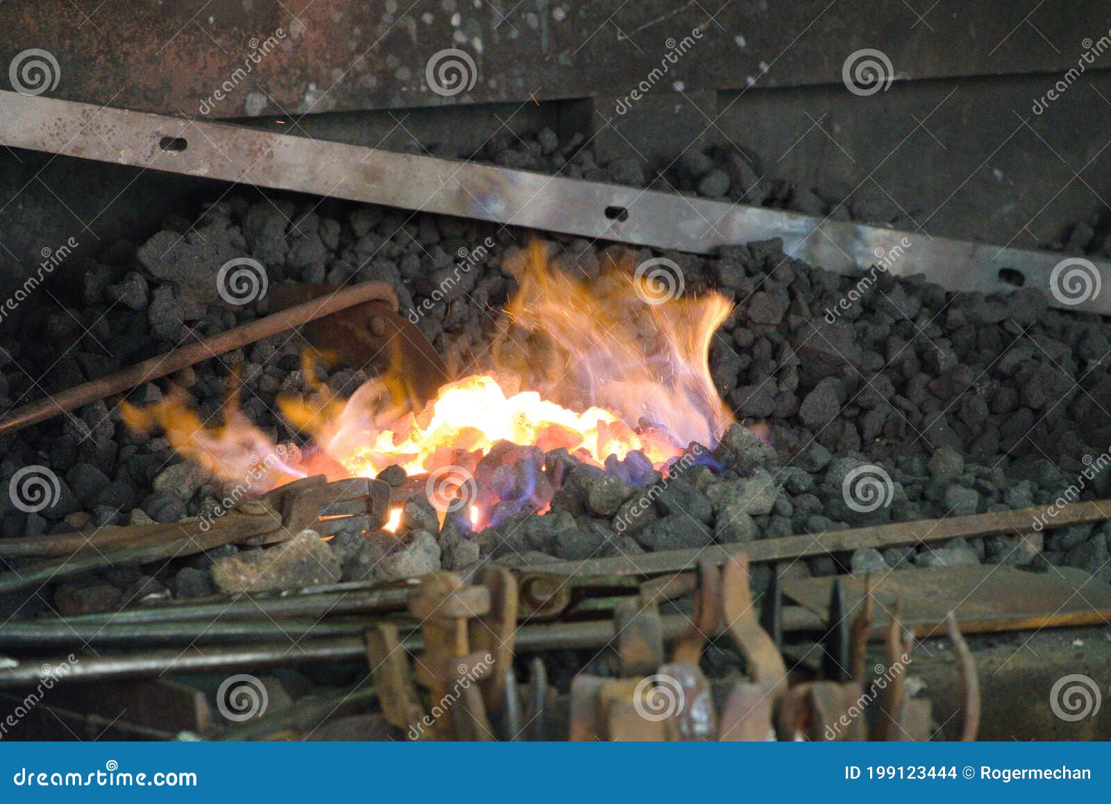 Blacksmith Working at His Forge with Metal in White Flame Editorial ...