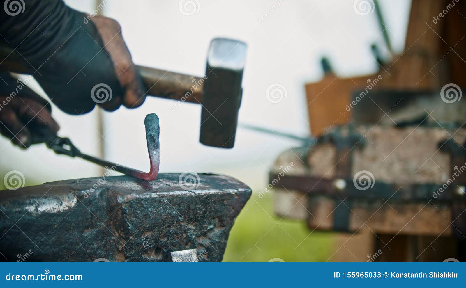 Blacksmith Working with an Iron Details in His Workshop - Hitting the ...