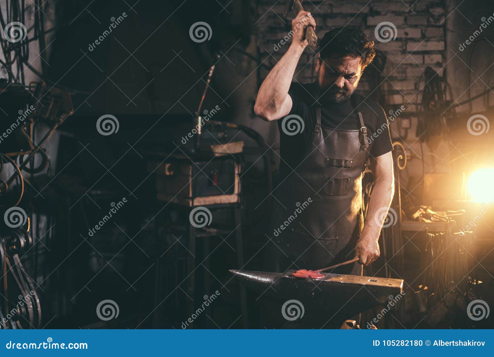 Blacksmith Working Metal with Hammer on Anvil in the Forge Stock Photo ...