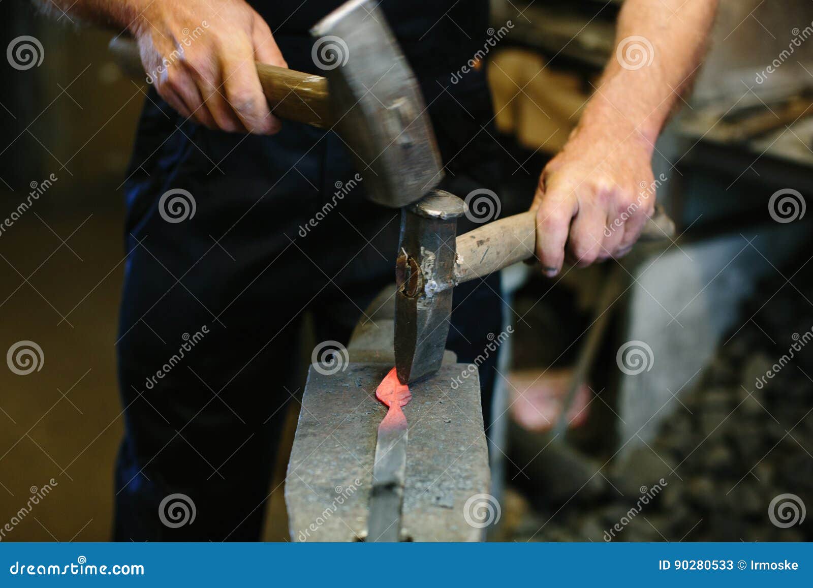 Blacksmith Working Metal with Hammer on the Anvil in the Forge Stock ...