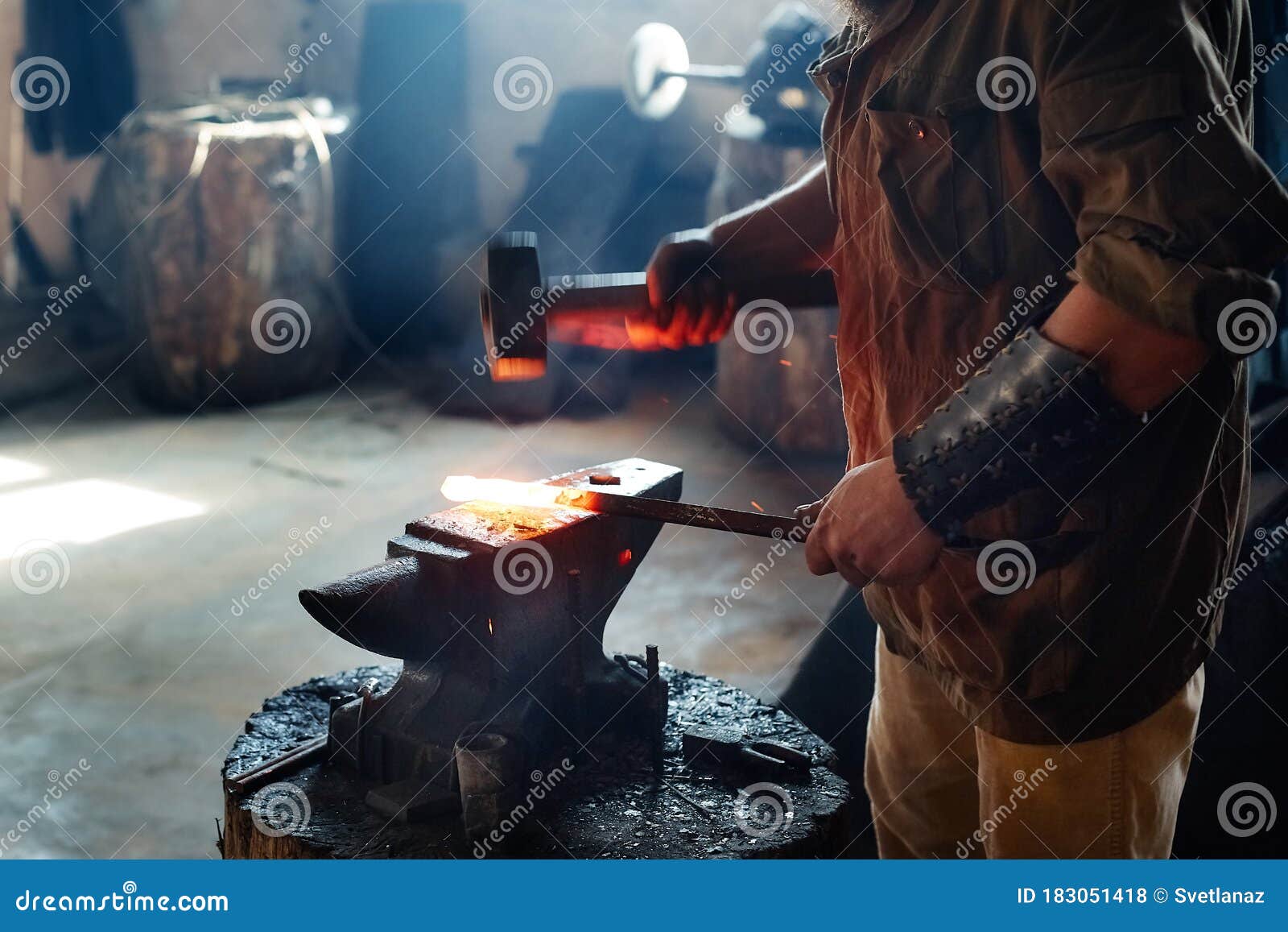 Blacksmith Working Metal with Hammer on the Anvil in the Forge Stock ...