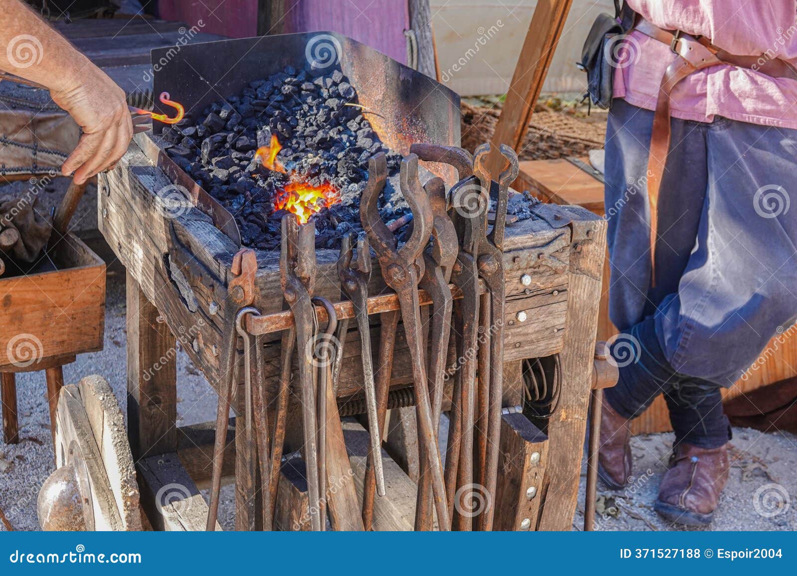 Blacksmith Working With Hot Glowing Metal, Bending Steel In A Smithery ...