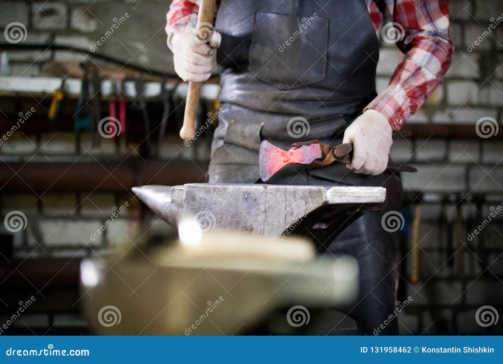 Blacksmith Working with Red Hot Metal Workpiece of Axe on the Anvil at ...