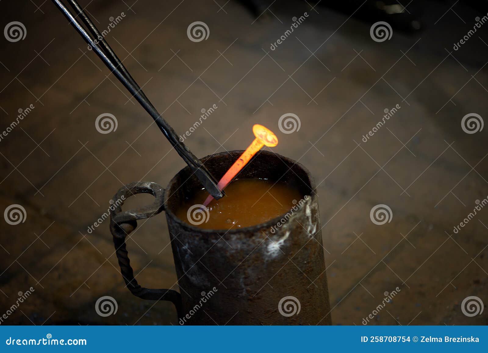Blacksmith with Working Tools Puts a Hot Melal Nail in the Water Stock ...
