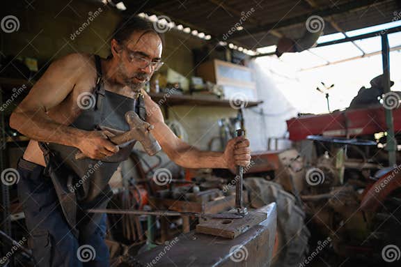 Blacksmith Working in Workshop. Stock Image - Image of artistic ...