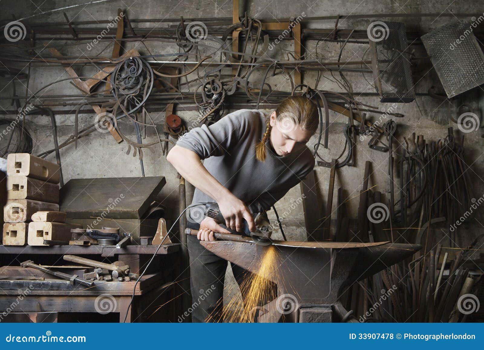 Blacksmith Working With Hot Glowing Metal, Bending Steel In A Smithery ...