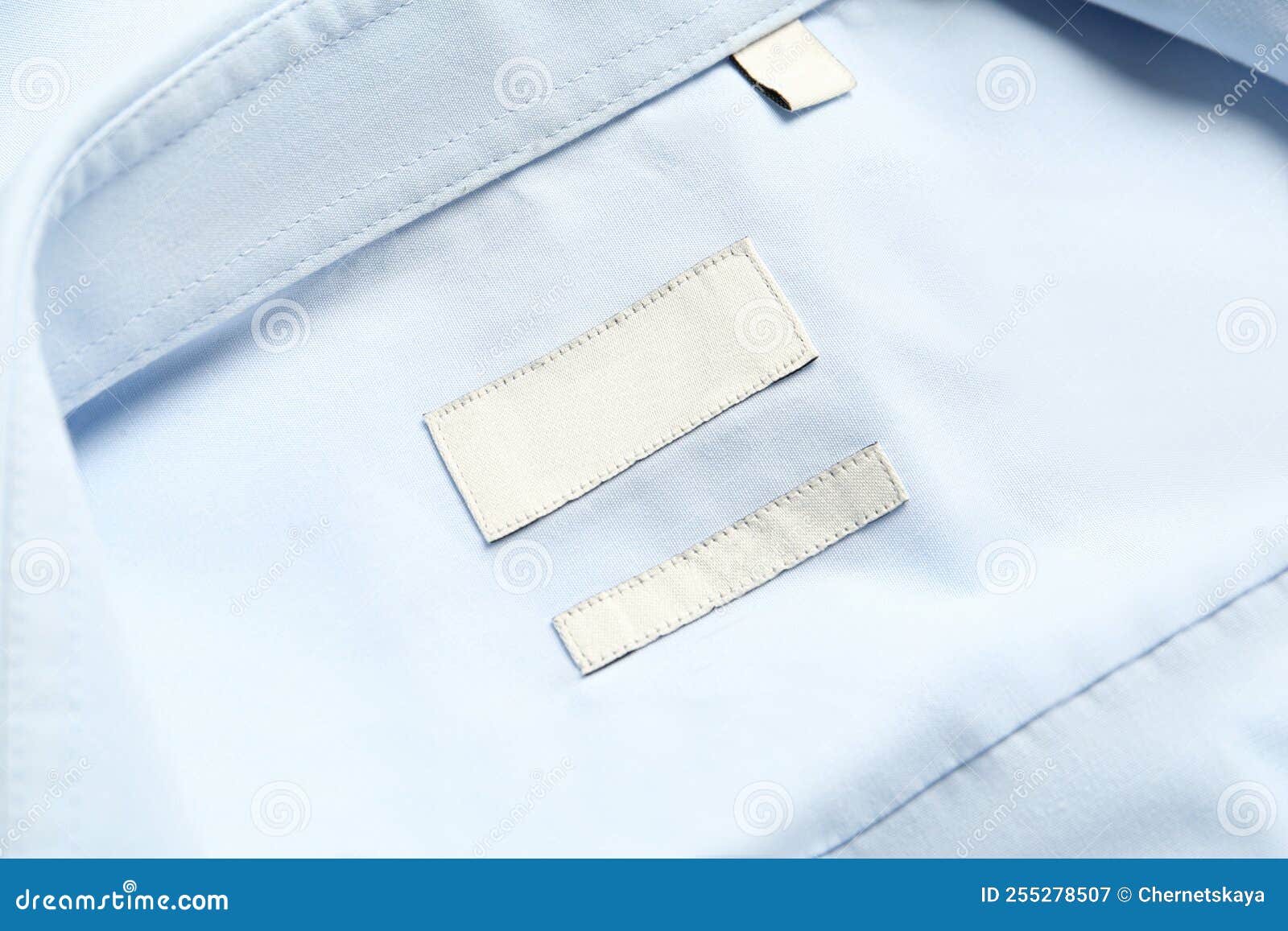 Blank Clothing Labels on Light Blue Shirt, Top View Stock Image - Image ...