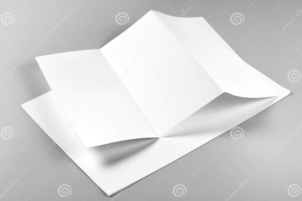 Blank Folded Flyer or Letterhead Over Stack of Paper Stock Image ...