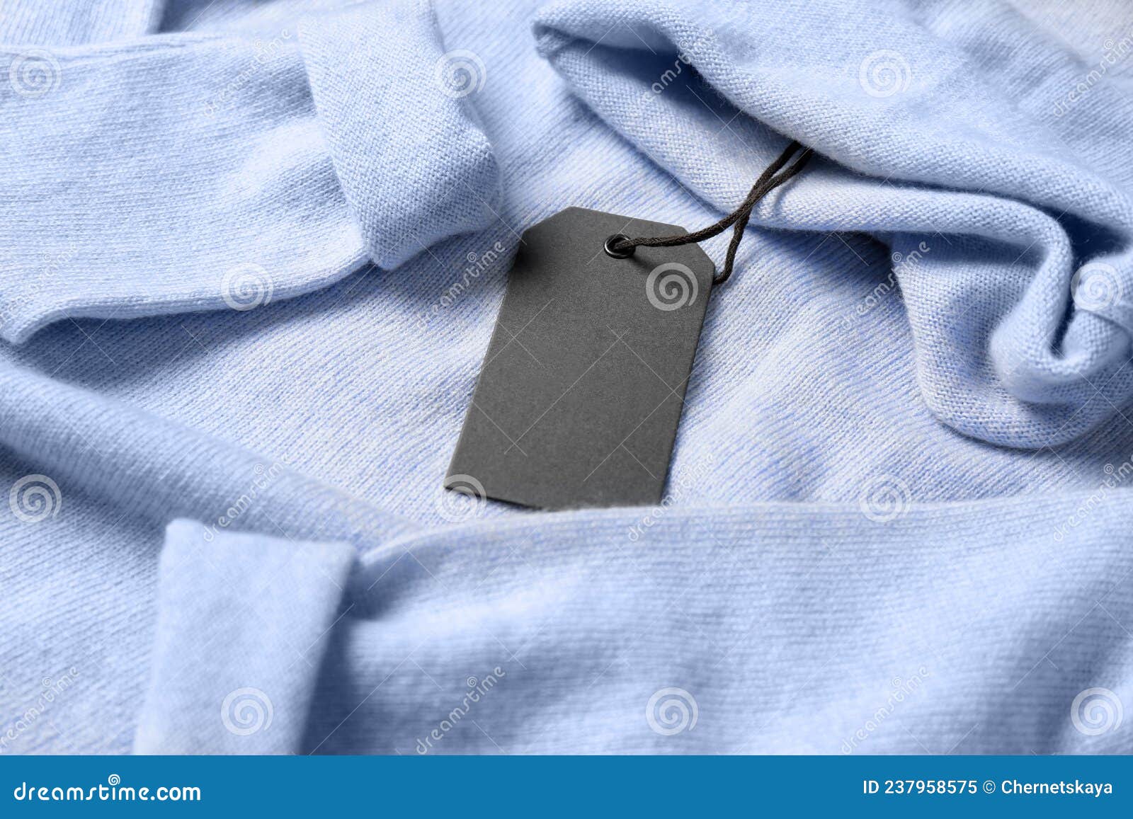 Blank Grey Tag on Light Blue Sweater. Space for Text Stock Image ...