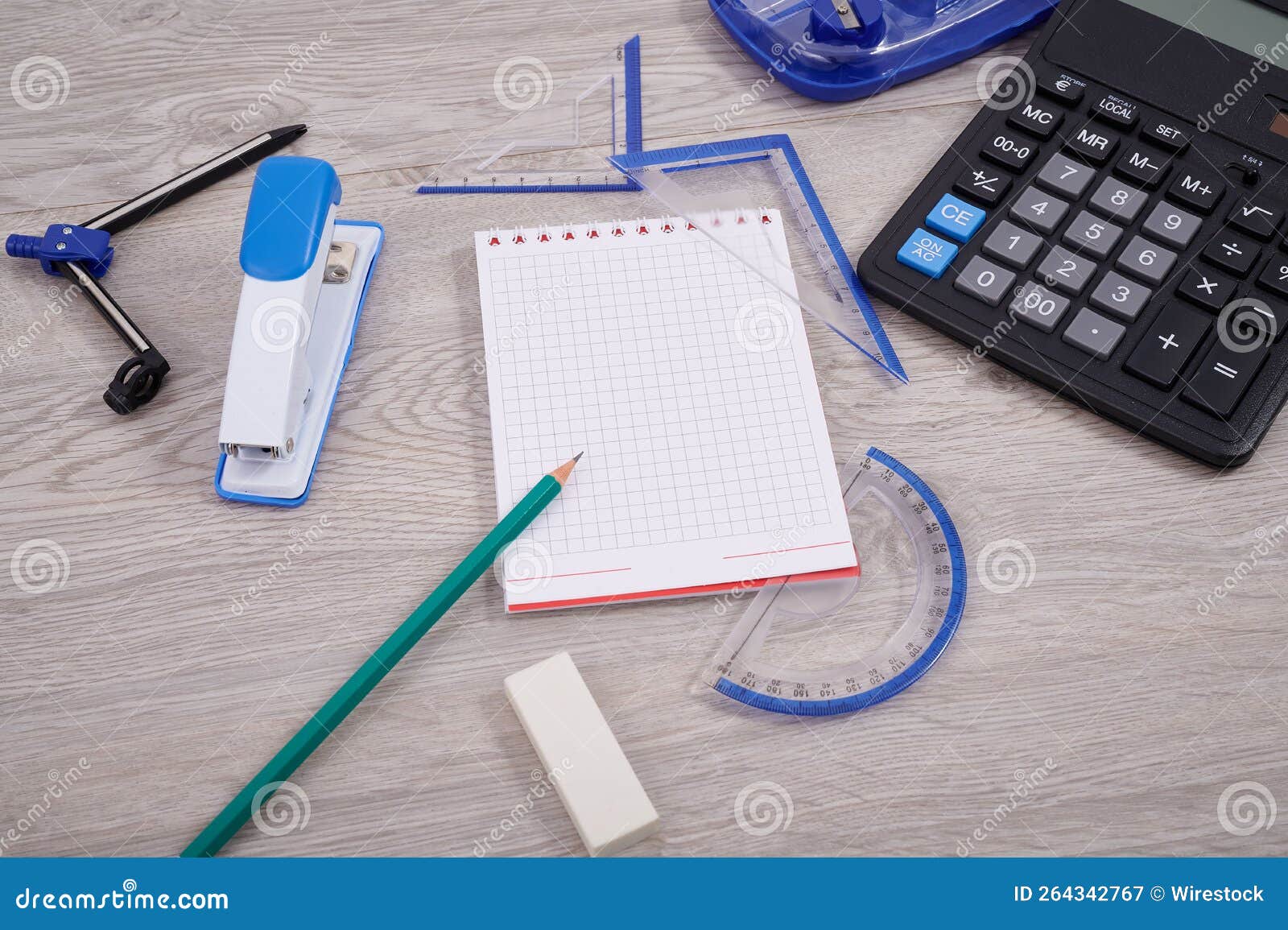 Blank Notebook Page with a Calculator and Geometric Stationery Over ...