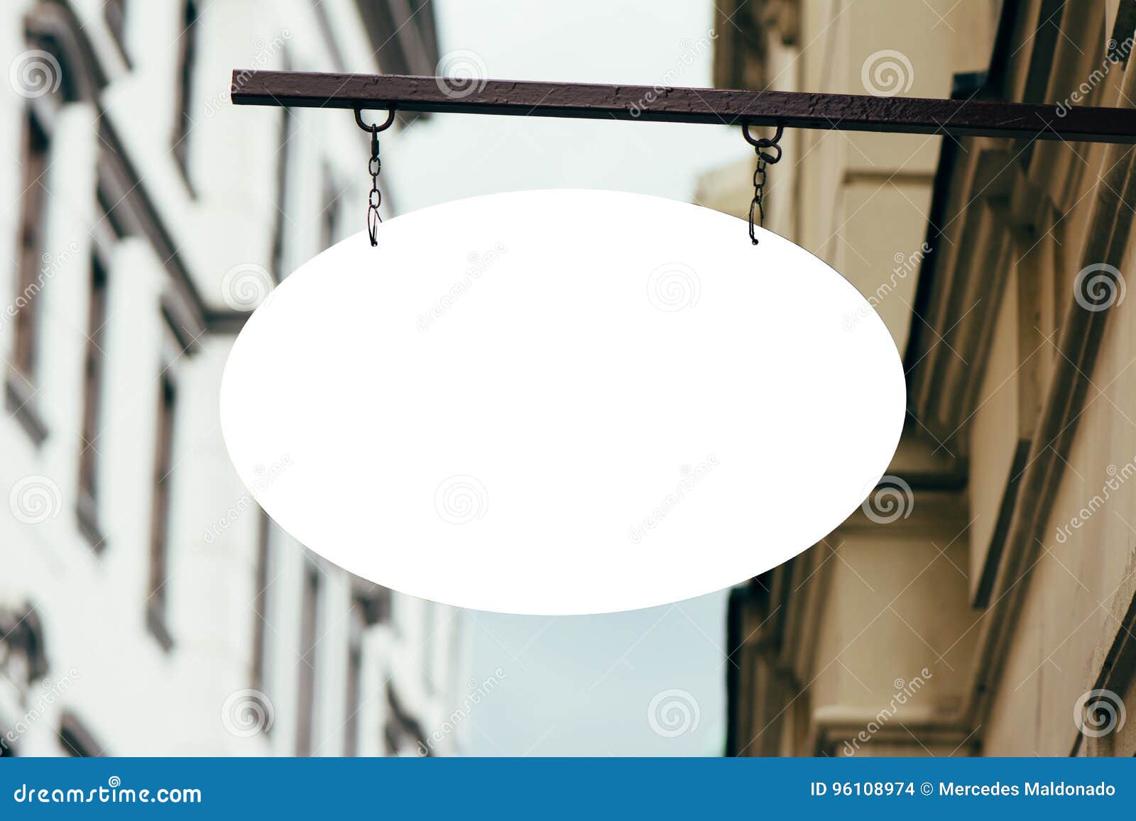 Blank Oval Signage Hanging from Wrought Iron Bracket Stock Photo ...