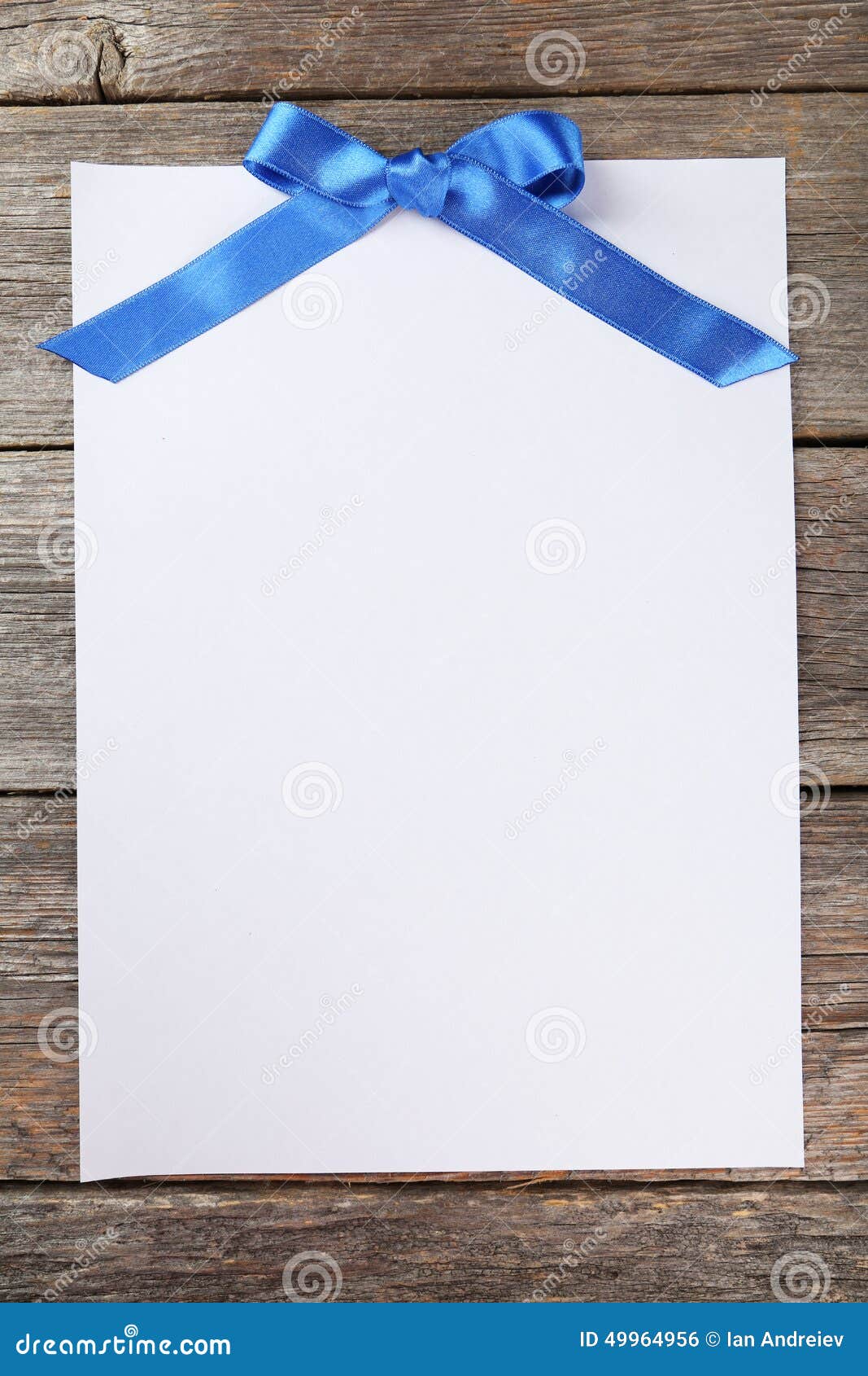 Blank Paper Sheet with Blue Bow on a Grey Wooden Background Stock Photo ...