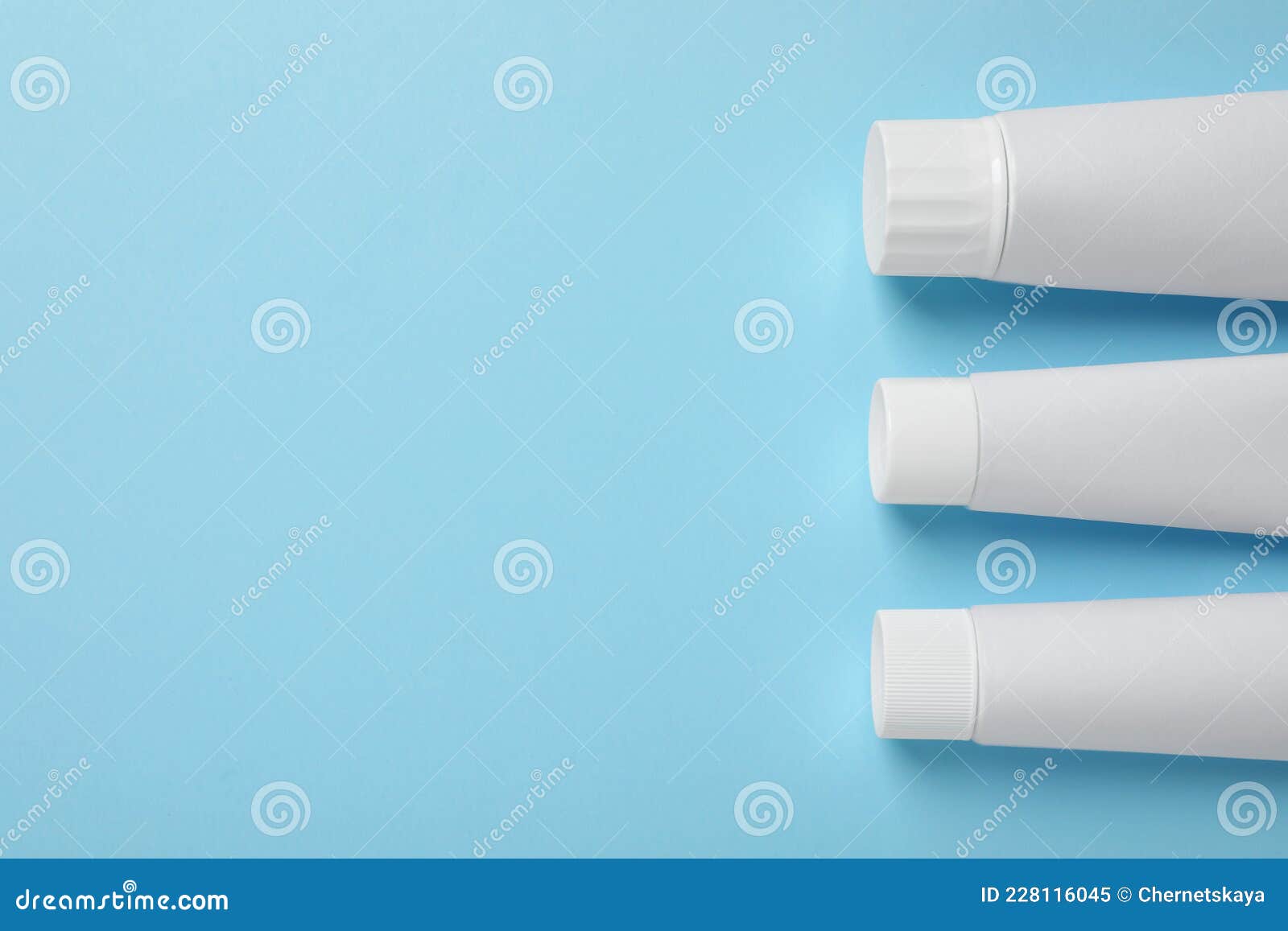 Blank Tubes of Toothpaste on Light Blue Background, Flat Lay. Space for ...