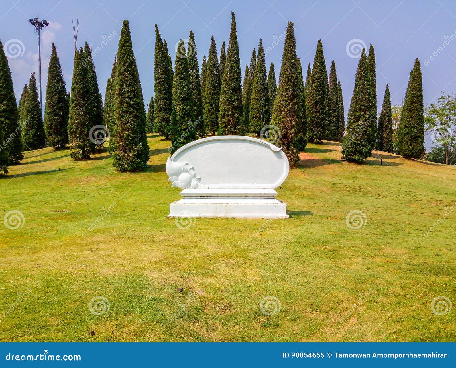 Blank White Concrete Oval Shaped Billboard in Pine Tree Garden Stock ...