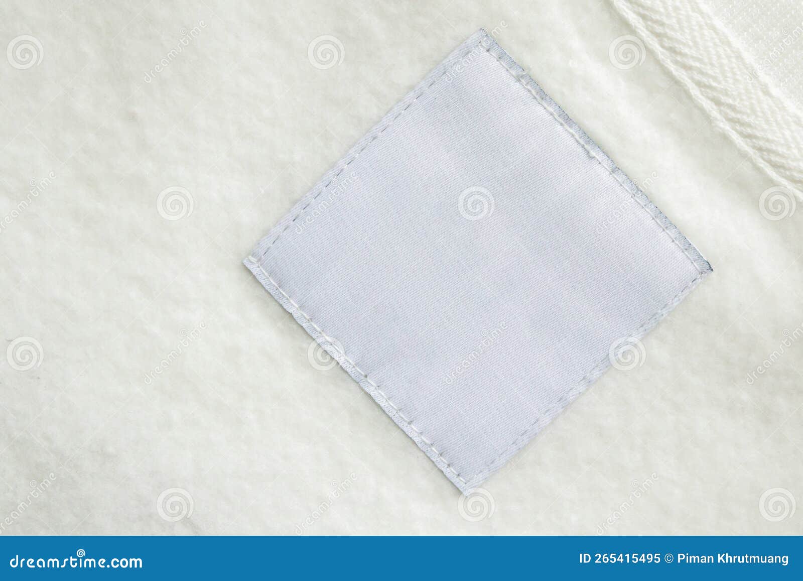 Blank White Laundry Care Clothes Label on Fabric Texture Background ...