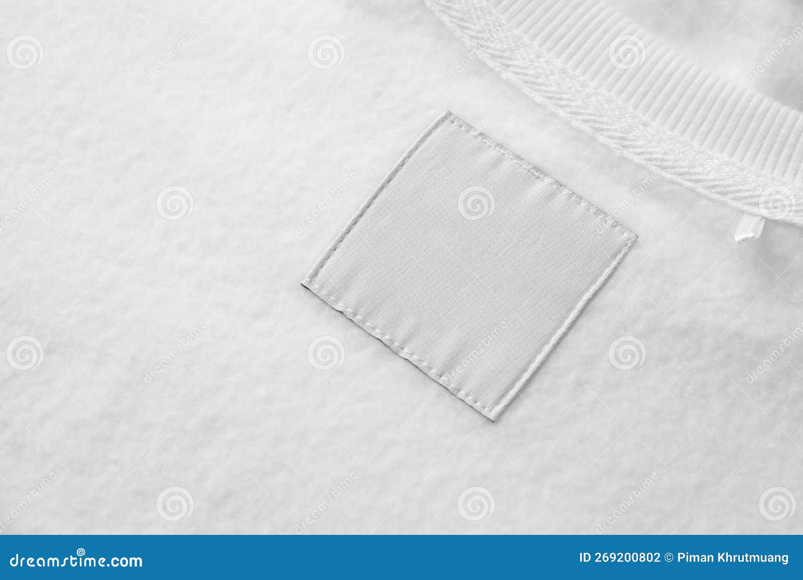 Blank White Laundry Care Clothes Label on Fabric Texture Background ...