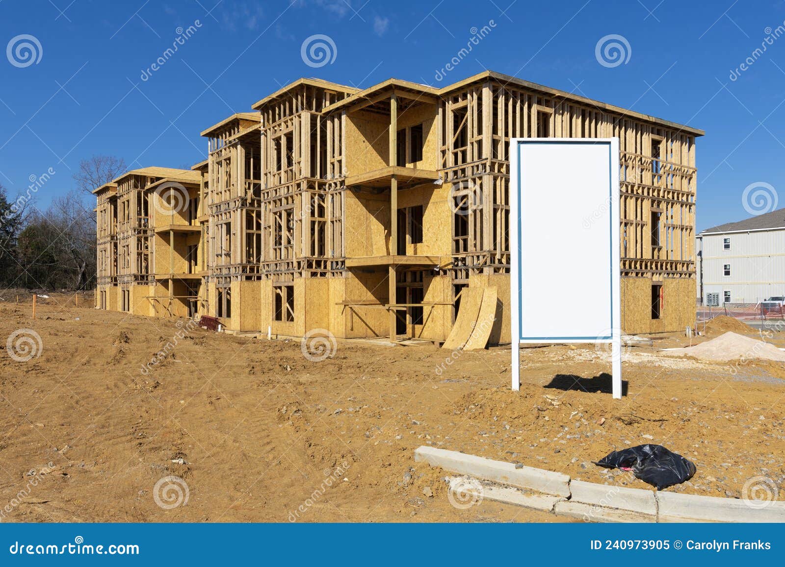 Blank White Sign in Front of New Apartment Complex Construction Stock ...