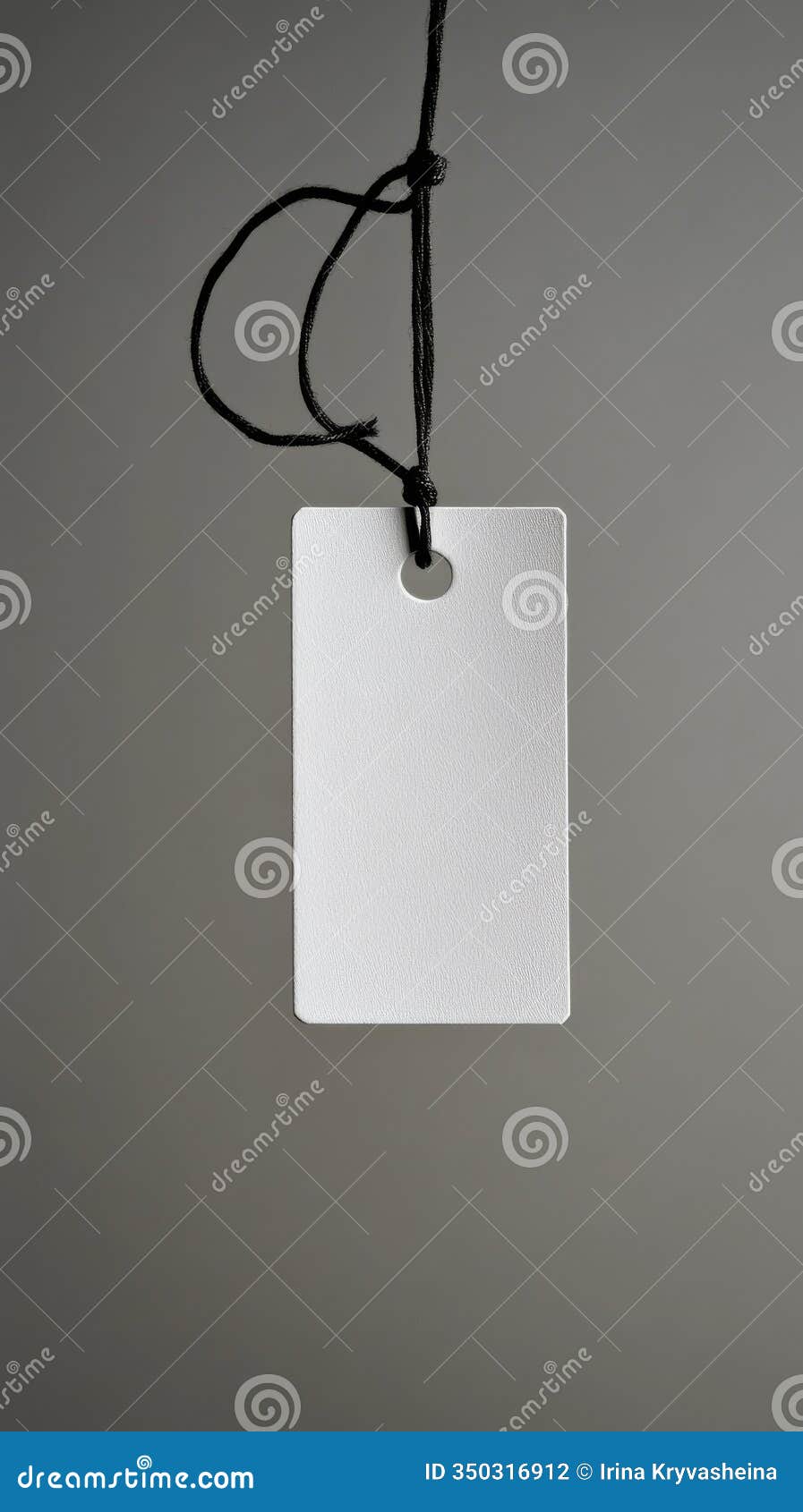 Blank White Tag Hanging from a Black String Against a Gray Background ...
