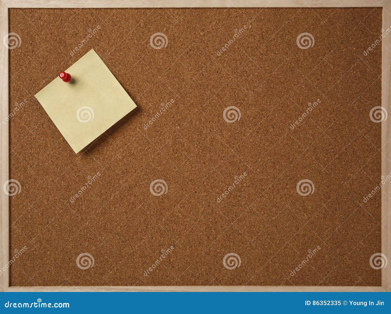 Blank Yellow Sticky Note Pinned on a Cork Bulletin Board. Stock Image ...