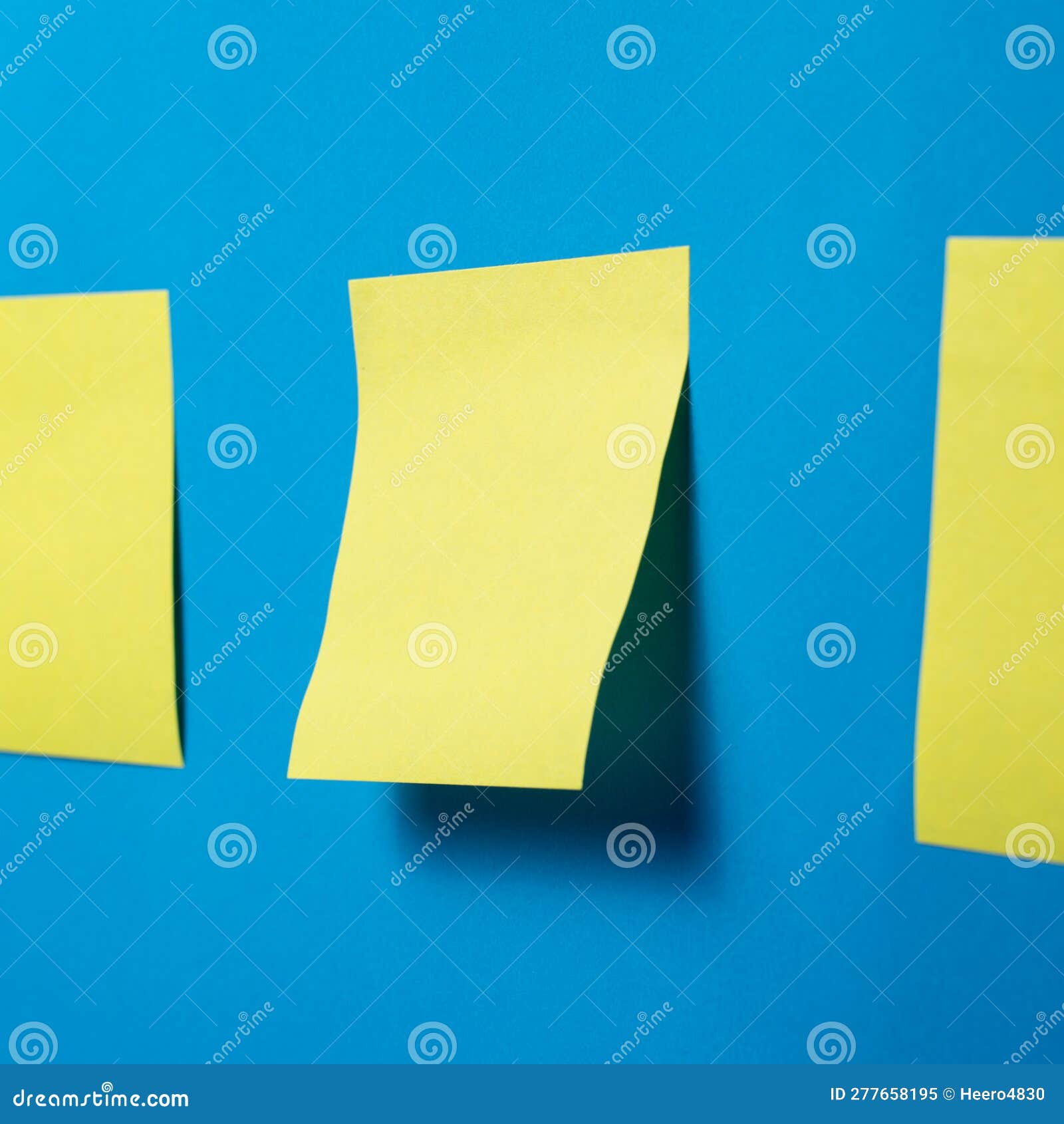 Blank Yellow Sticky Notes on Blue Wall Stock Image - Image of paper ...