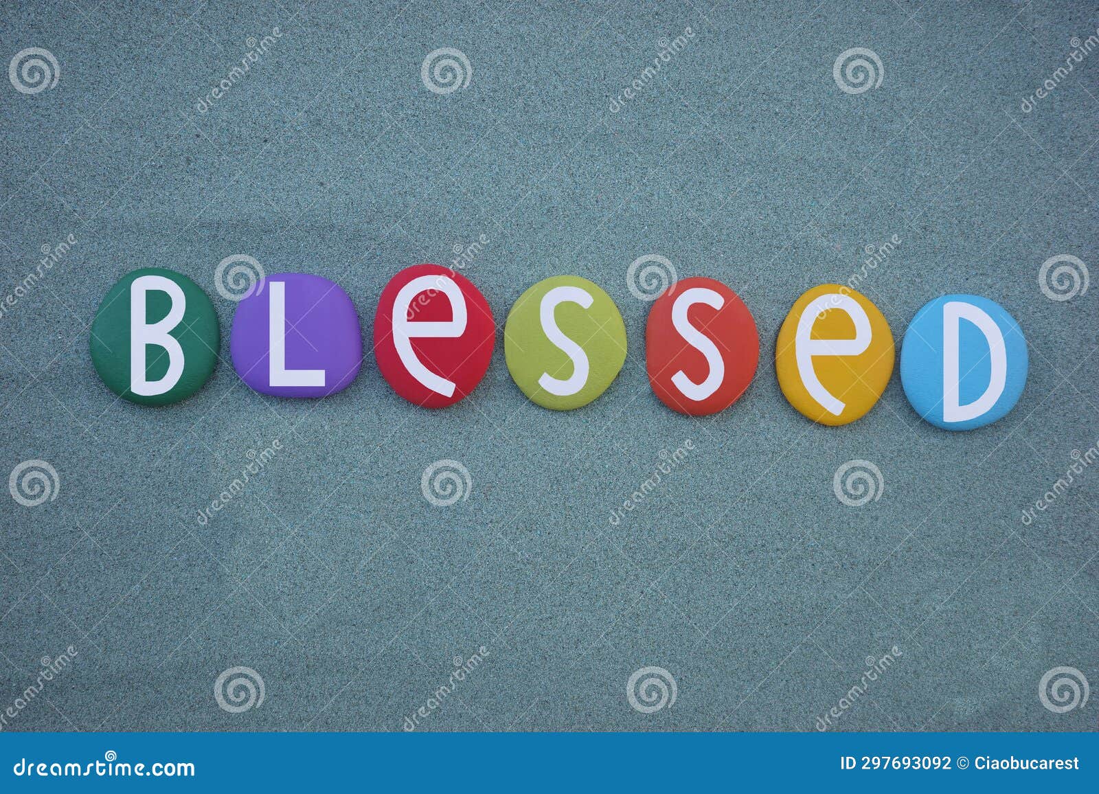 Blessed Word Composed with Multi Colored Stone Letters Over Green Sand ...
