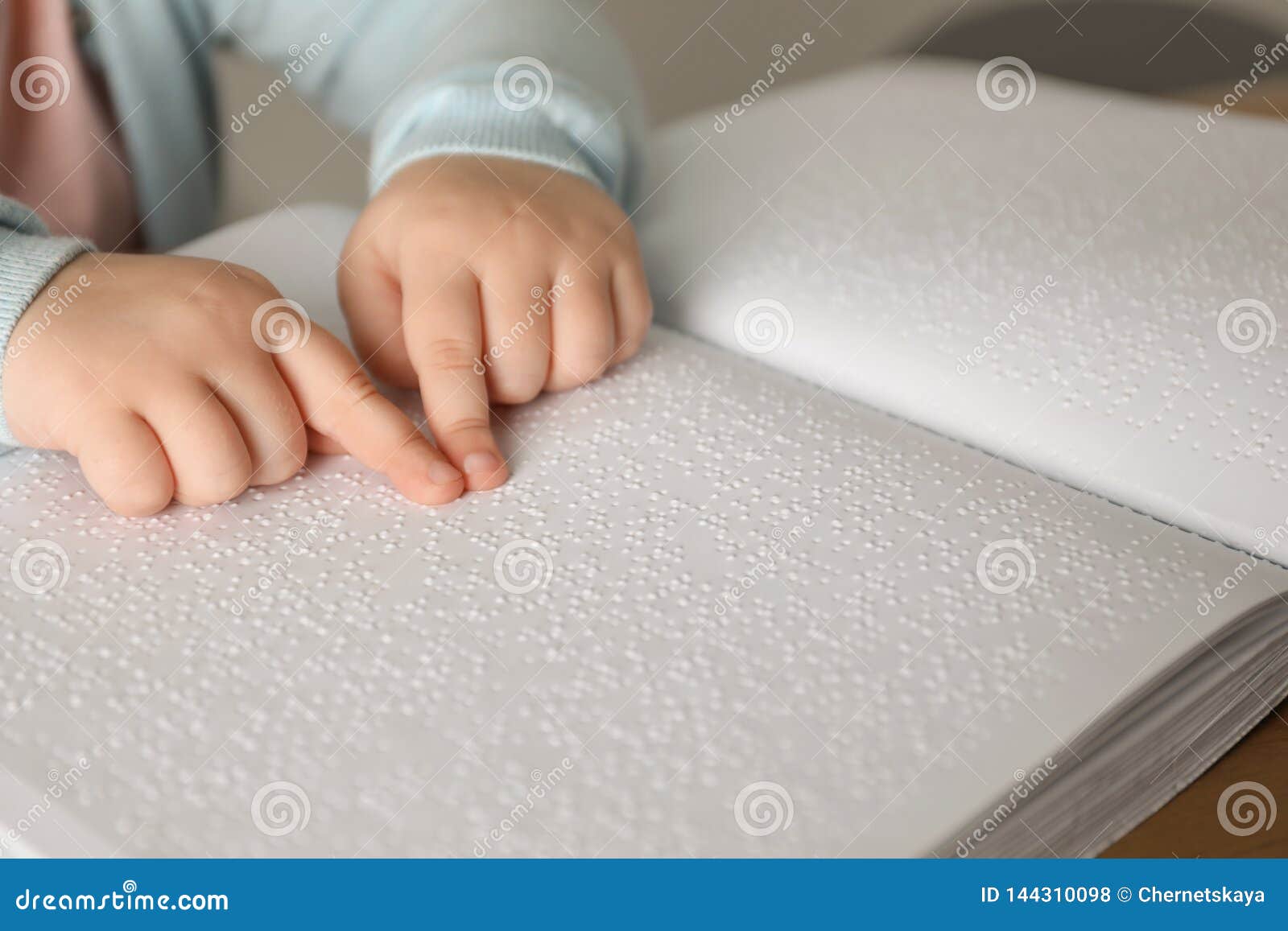 Blind Child Reading Book Written In Braille At Table Royalty-Free Stock ...
