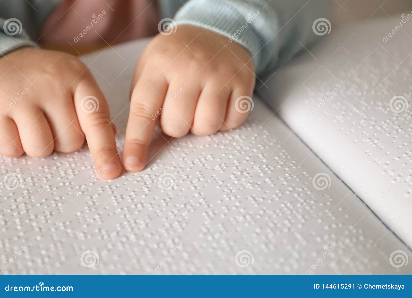 Blind Child Reading Book Written In Braille At Table Royalty-Free Stock ...