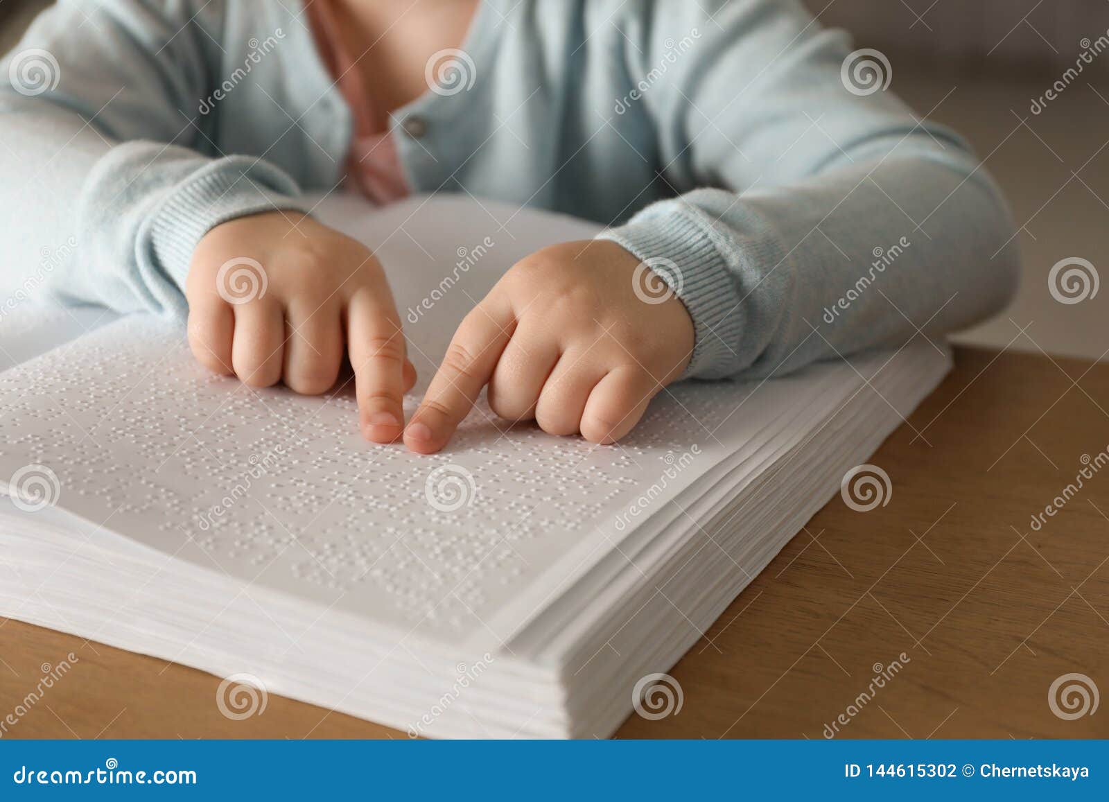 Blind Child Reading Book Written in Braille at Table Stock Photo ...