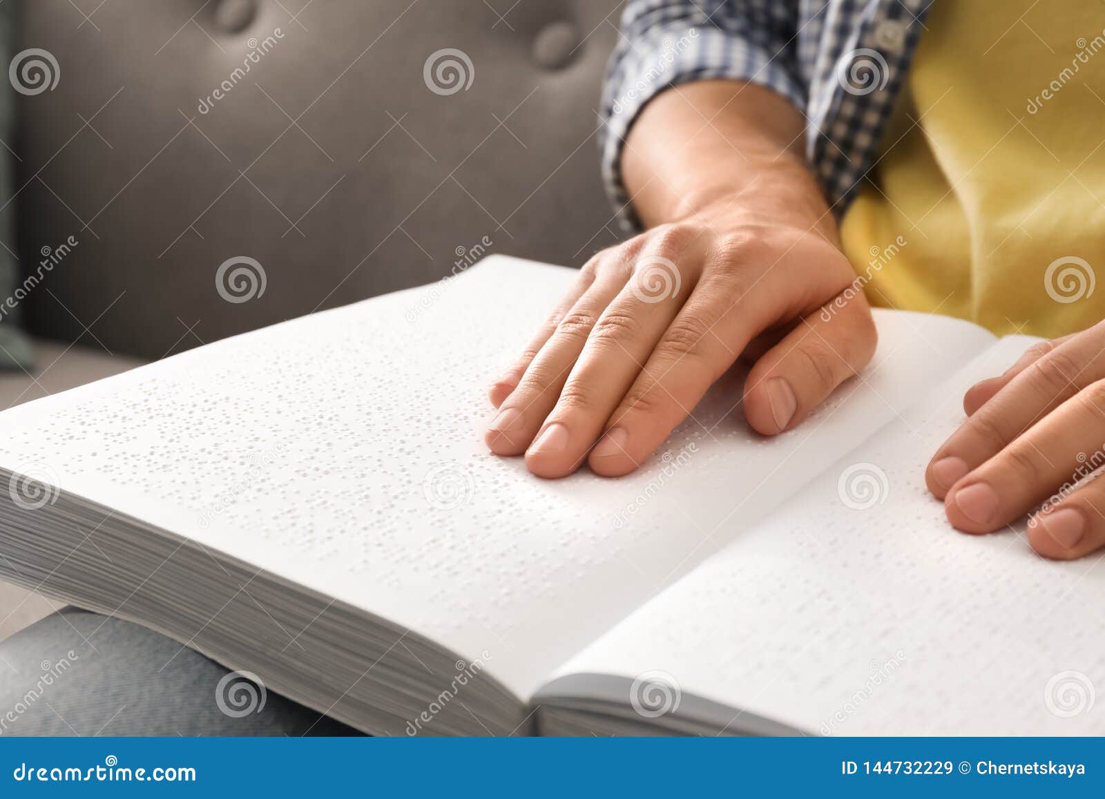 Blind Man Reading Book Written in Braille on Sofa Stock Image - Image ...