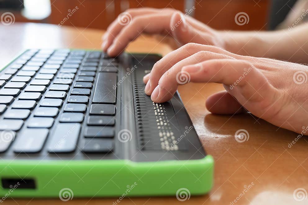 A Blind Man Uses a Computer with a Braille Display and a Computer ...