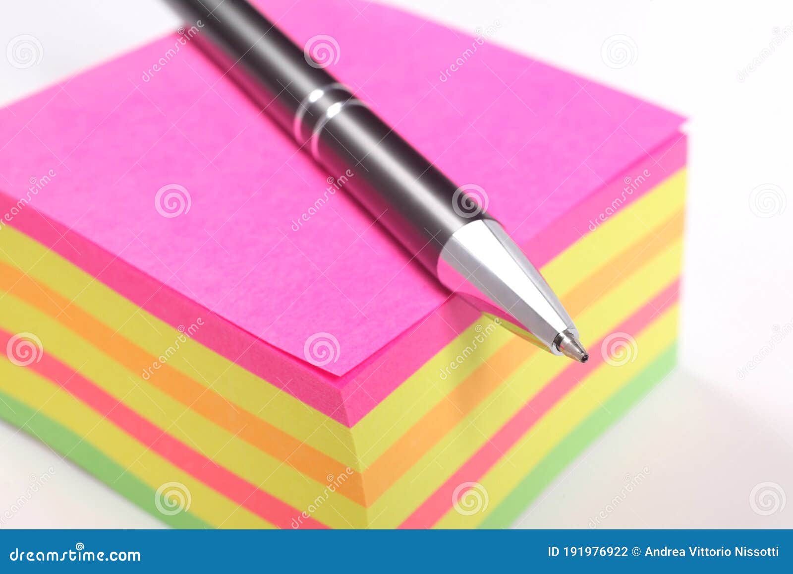 Block Of Colored Sticky Notes And A Pen Isolated On White Background ...