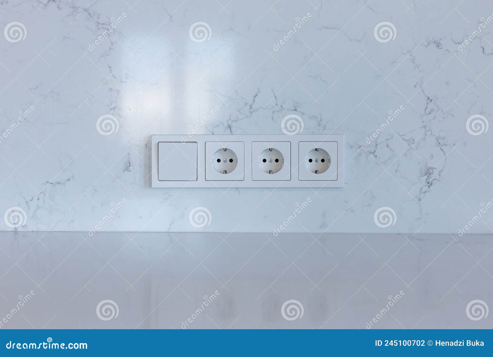 Block of Three Sockets and a Switch on a White Wall Stock Photo - Image ...