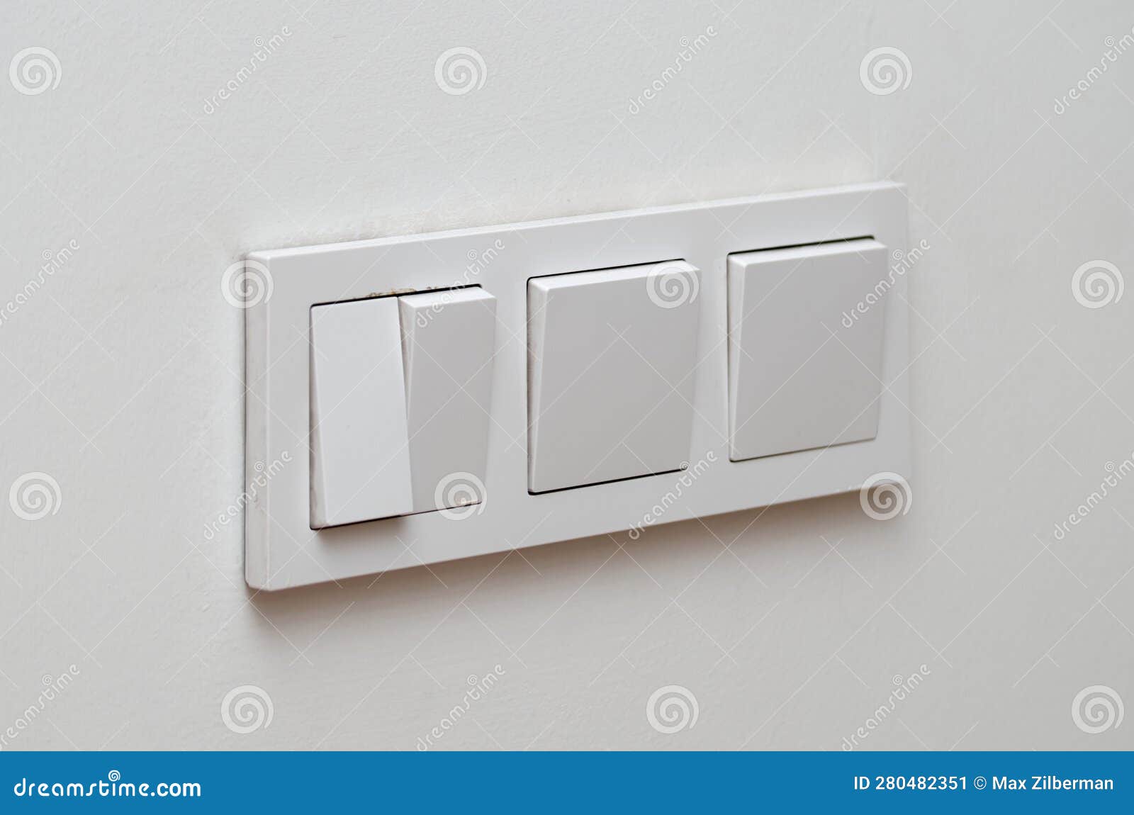 Block of Three White Plastic Electrical Switches on a White Wall Stock ...