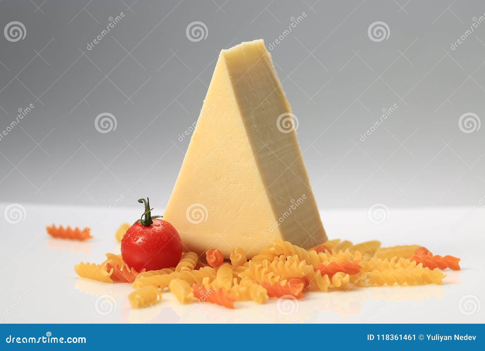 Block and Triangle Sliced Cheese with a Slice of Tomato Stock Image ...