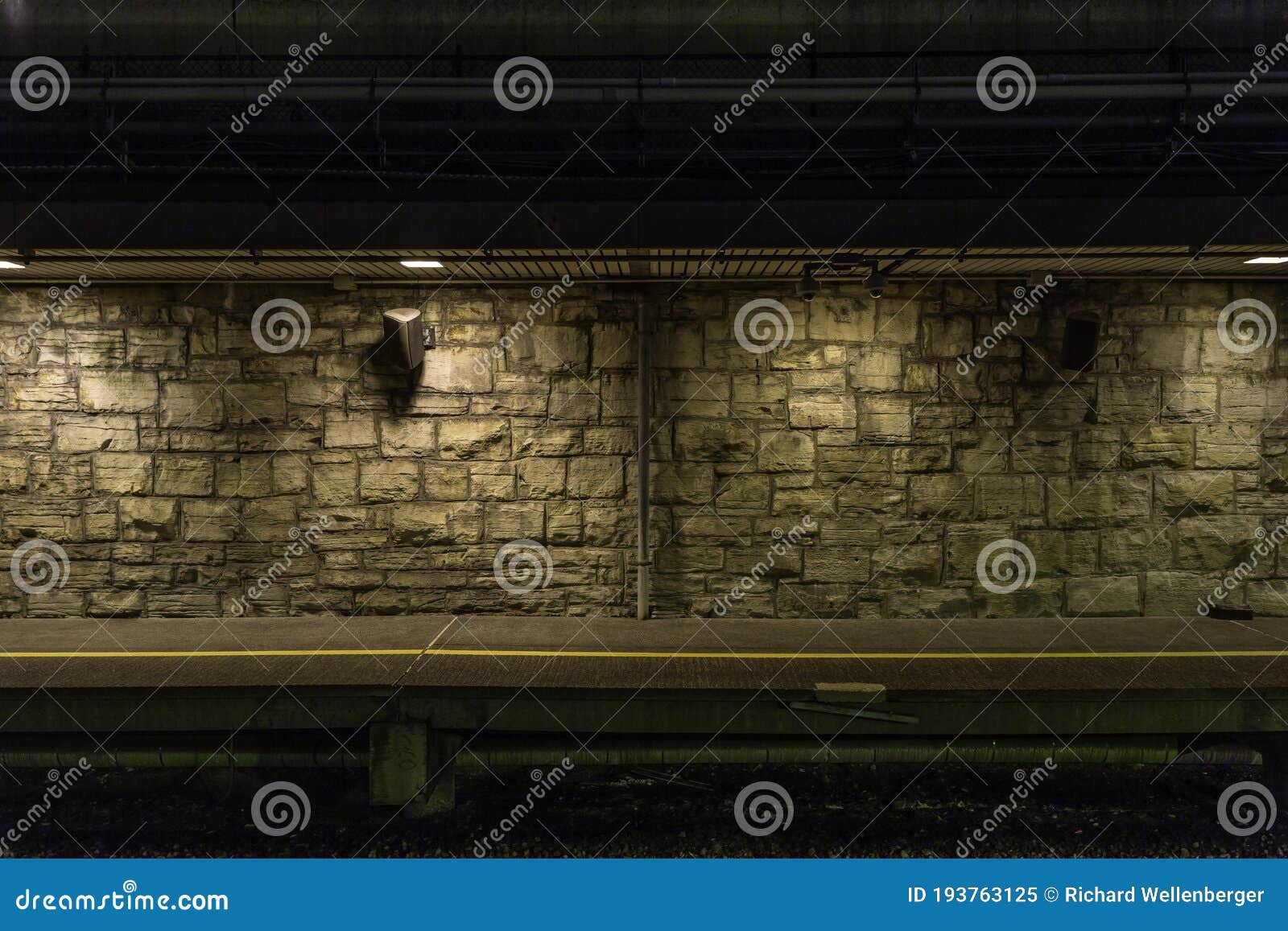 Block Wall of Empty Train Platform with Lights Stock Image - Image of ...