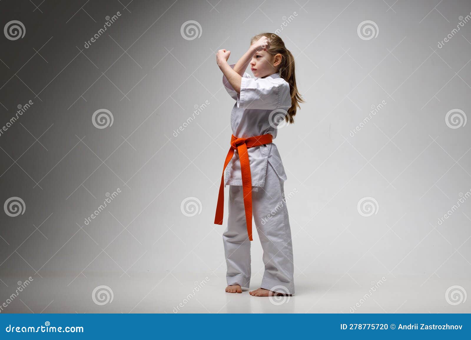 Blocking Punches Karate, Child Girl Trains on a White Background Stock ...