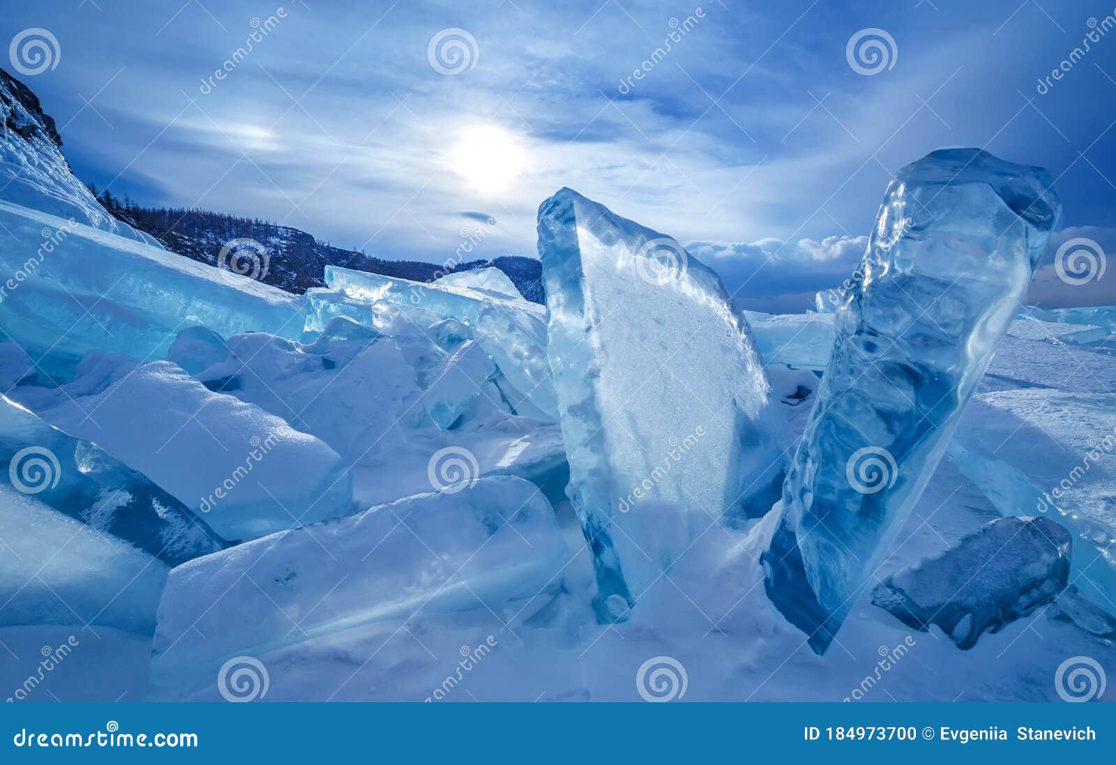 Blocks of Broken Blue Ice on Sky Background with Sun and Clouds Stock ...