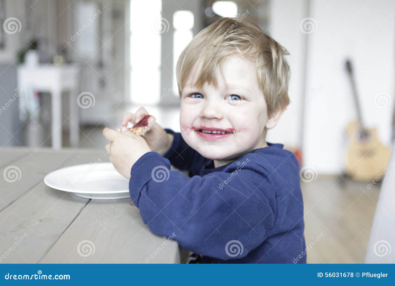 Blond boy eats jam stock photo. Image of young, breakfast - 56031678