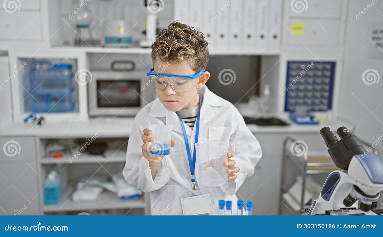 Blond Boy Scientist Doing Experiment at Laboratory Stock Photo - Image ...