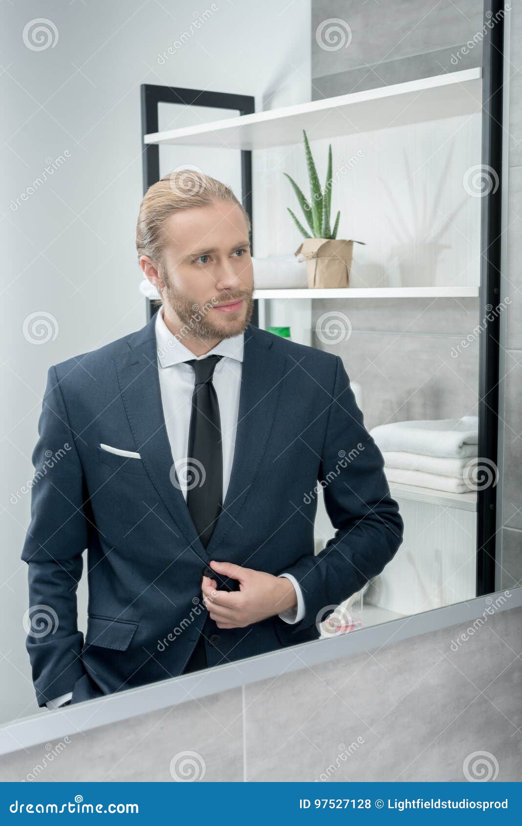 Blond Businessman in Suit Looking in the Mirror in Bathroom Stock Photo ...