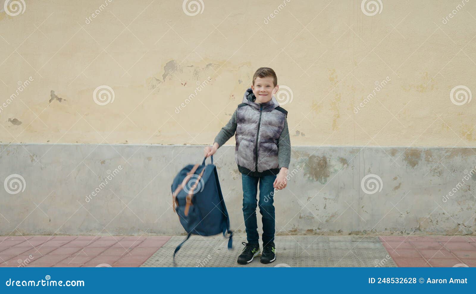 Blond Child Holding Backpack Jumping at Street Stock Footage - Video of ...
