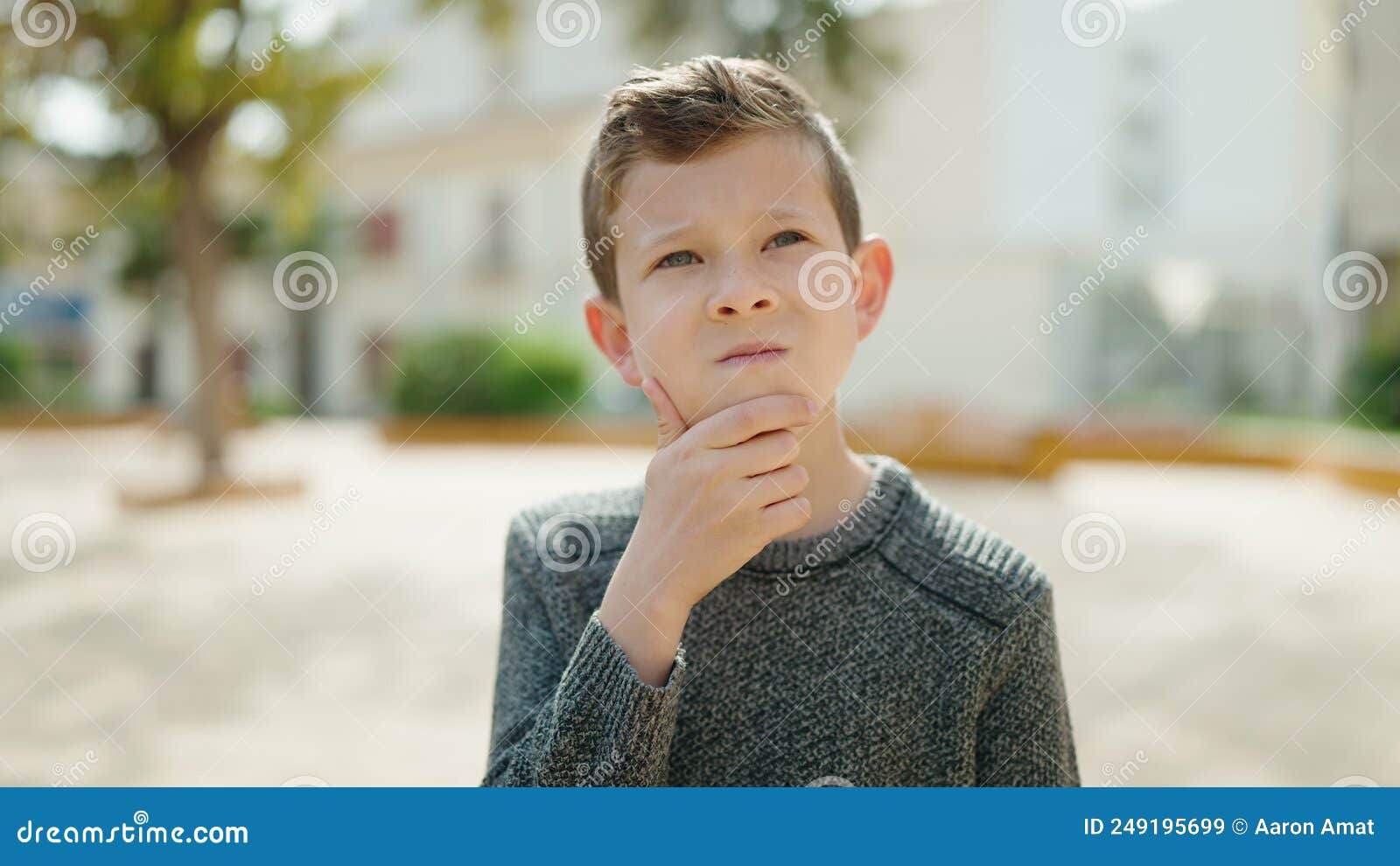 Blond Child Standing with Doubt Expression at Park Stock Video - Video ...