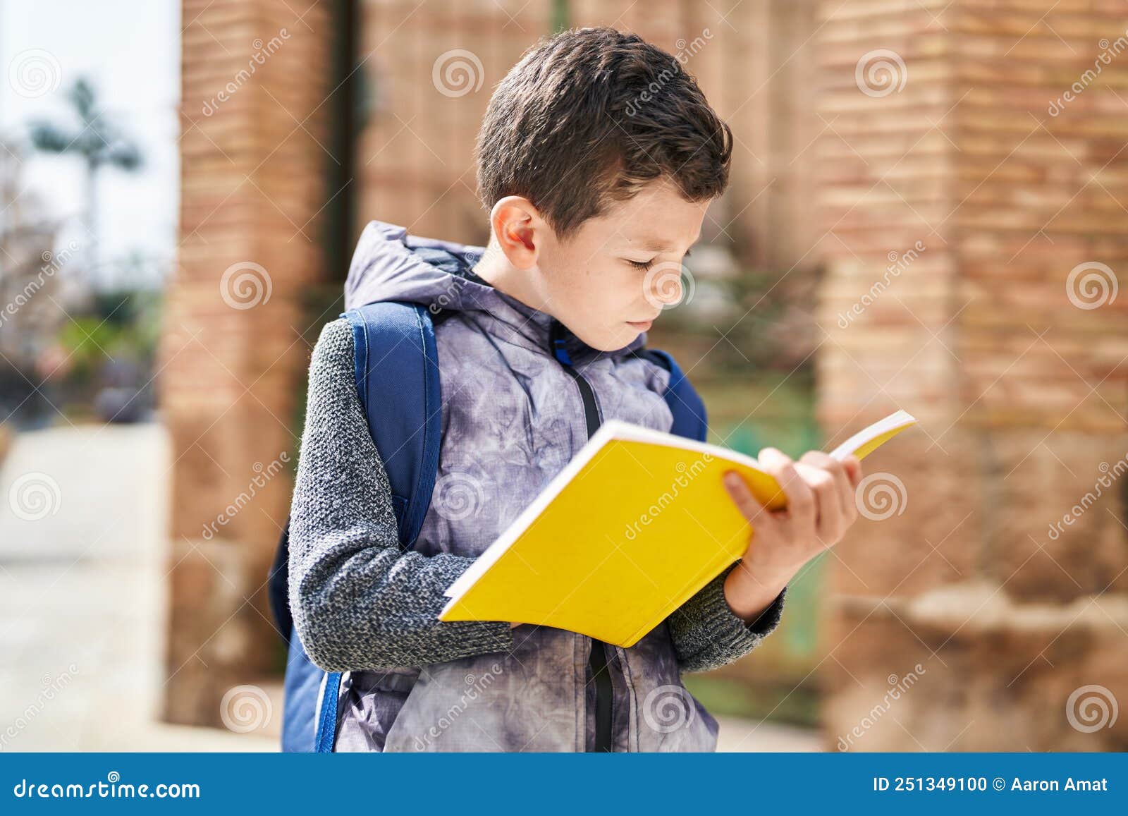 Blond Child Student Reading Book Standing at Street Stock Photo - Image ...