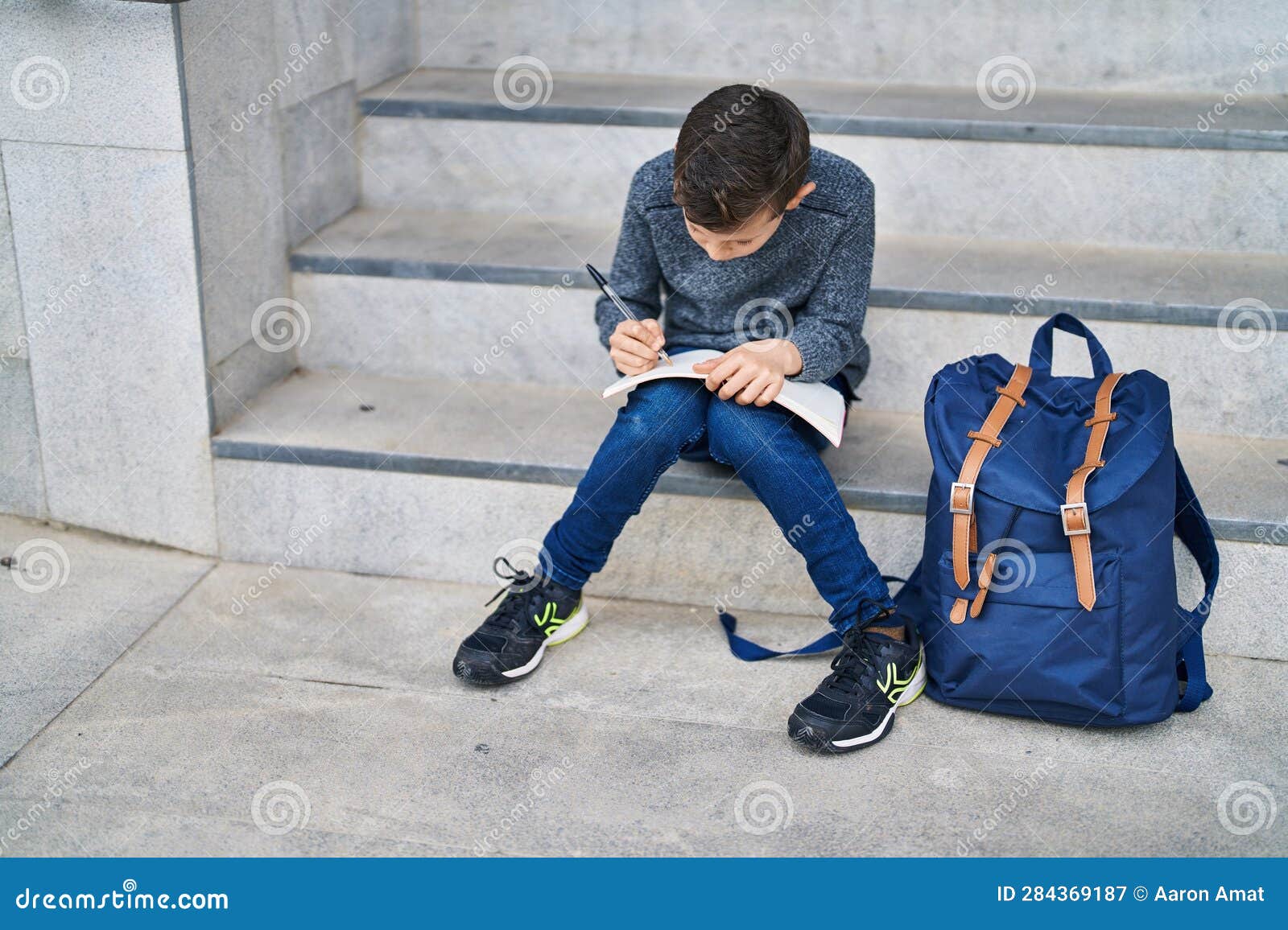 Blond Child Student Writing on Book Sitting on Stairs at School Stock ...