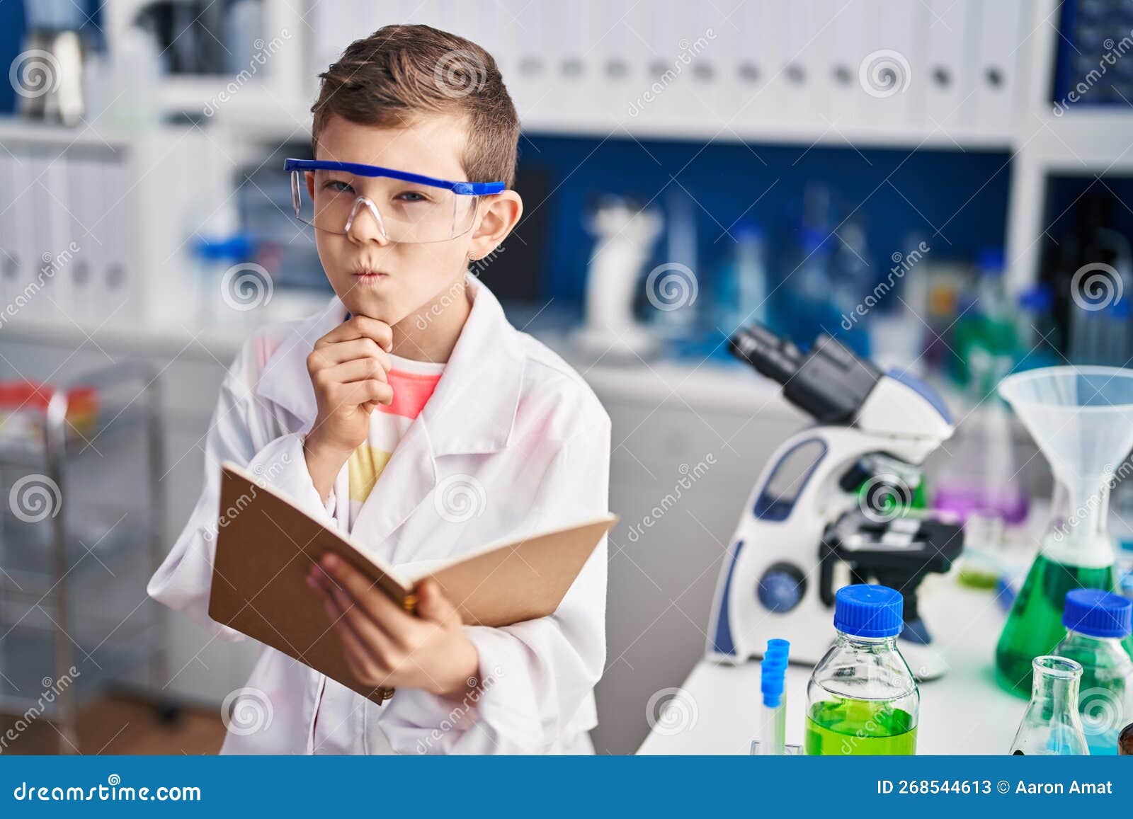 Blond Child Wearing Scientist Uniform Reading Book at Laboratory Stock ...