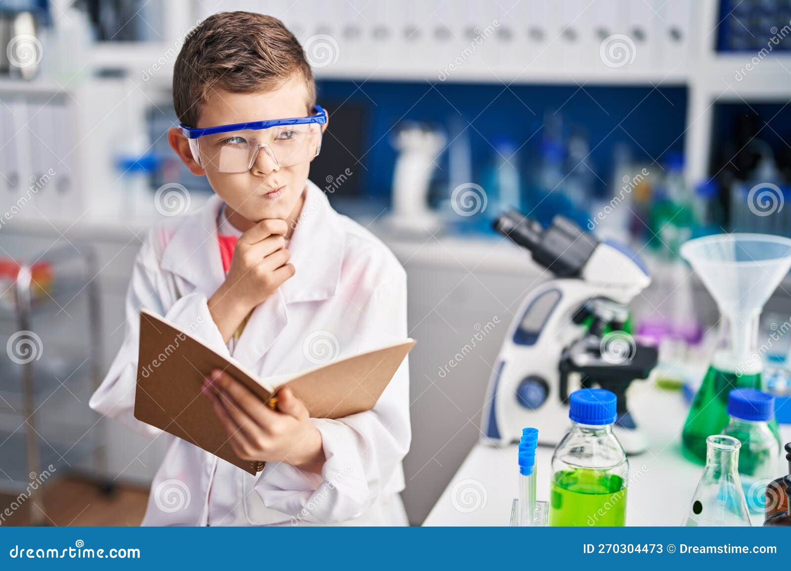 Blond Child Wearing Scientist Uniform Reading Book at Laboratory Stock ...
